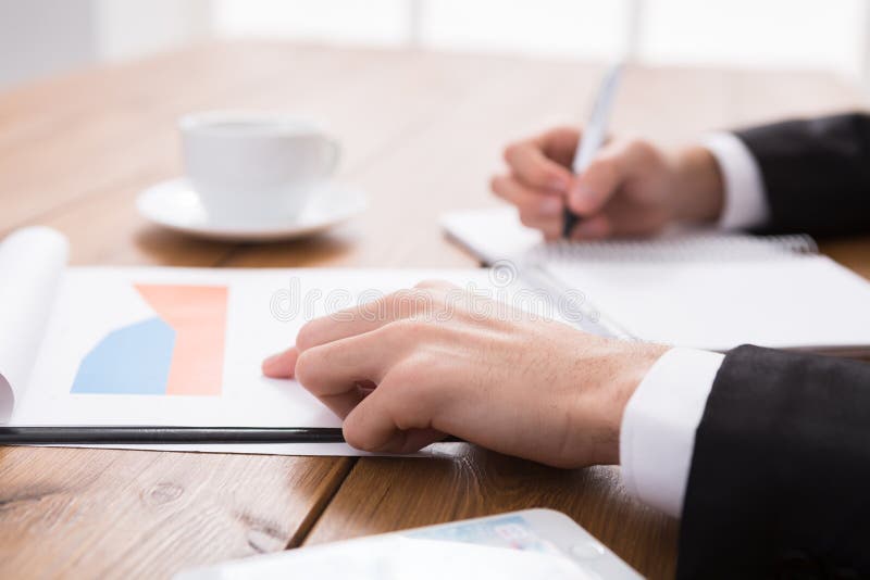 Man Taking Notes at Workplace, Side View Stock Photo - Image of sitting ...