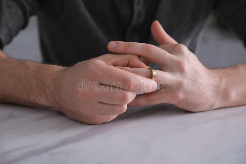 Man Taking Off Wedding Ring at White Marble Table, Closeup. Divorce ...