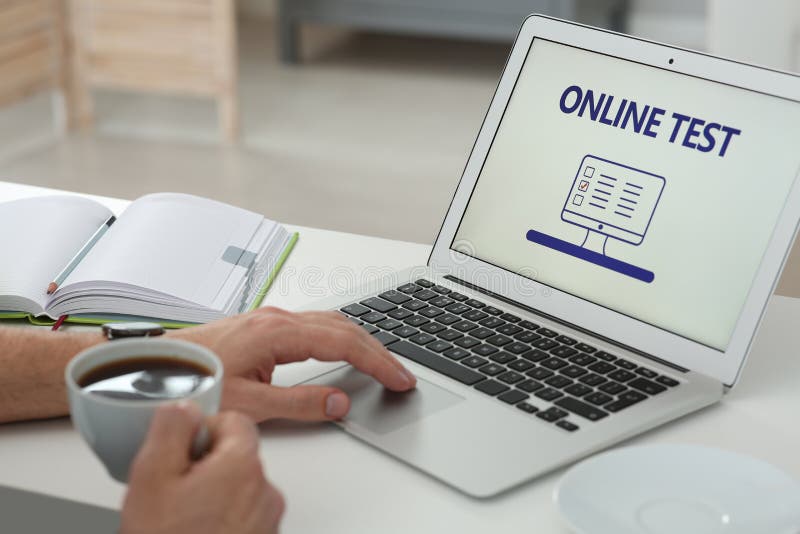 Man Taking Online Test on Laptop at Desk Indoors, Closeup Stock Photo ...