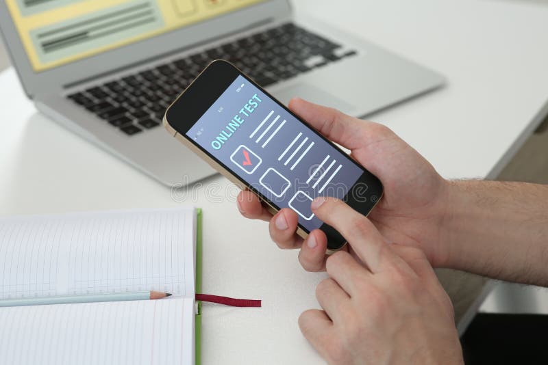 Man Taking Online Test on Smartphone at Desk, Closeup Stock Photo ...