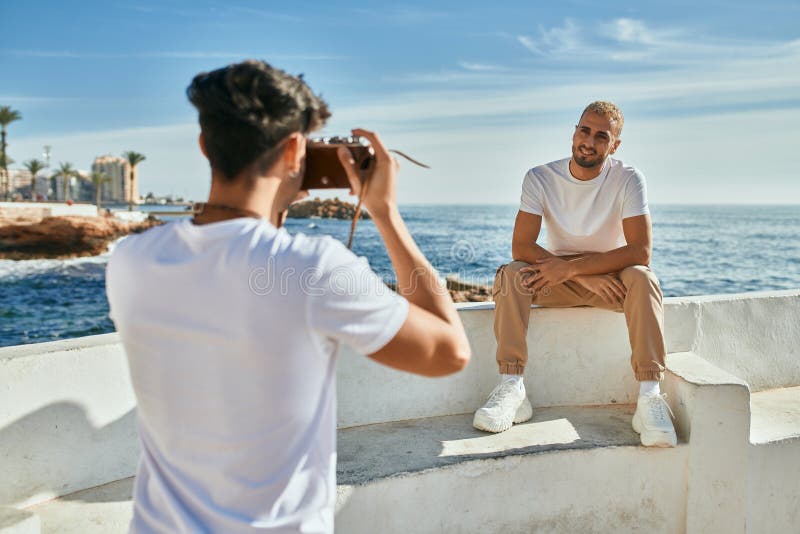 Man Taking Photos of His Boyfriend in Front of the Sea Stock Image ...