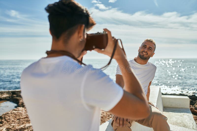 Man Taking Photos of His Boyfriend in Front of the Sea Stock Image ...