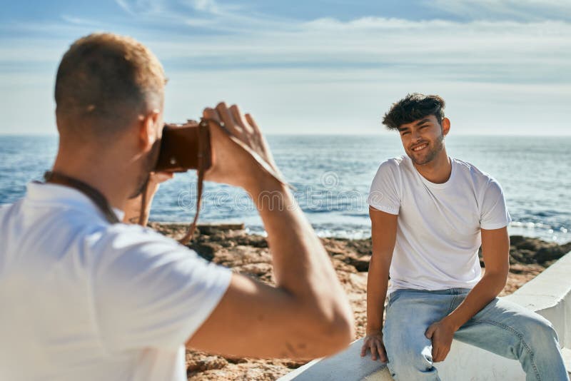 Man Taking Photos of His Boyfriend in Front of the Sea Stock Image ...