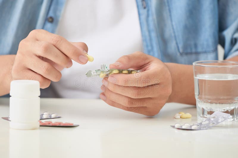 Man Taking Pill Out from Blister Pack at Home Stock Photo - Image of ...