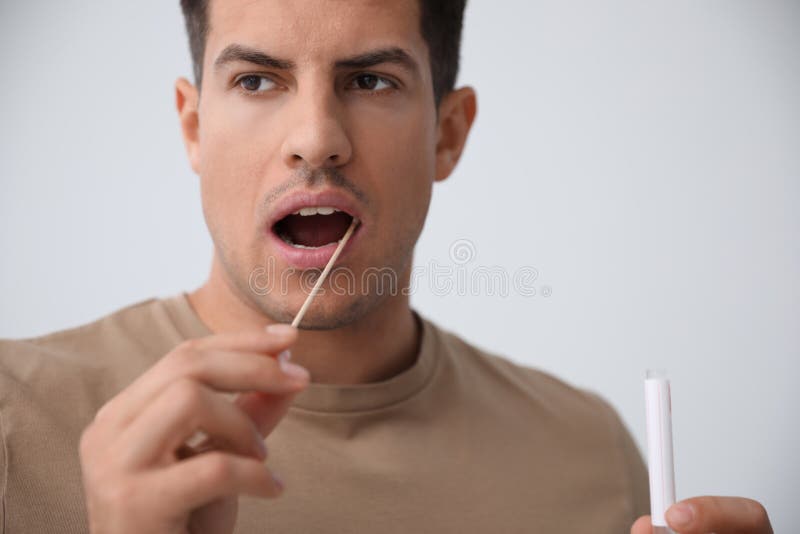 Man Taking Sample for DNA Test on Light Background Stock Photo - Image ...