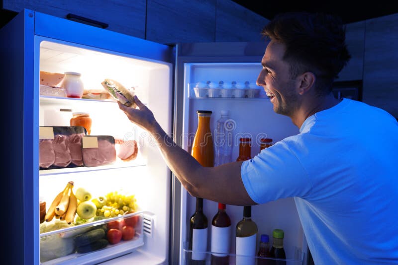 Man Taking Sandwich Out of Refrigerator in Kitchen Stock Photo - Image ...