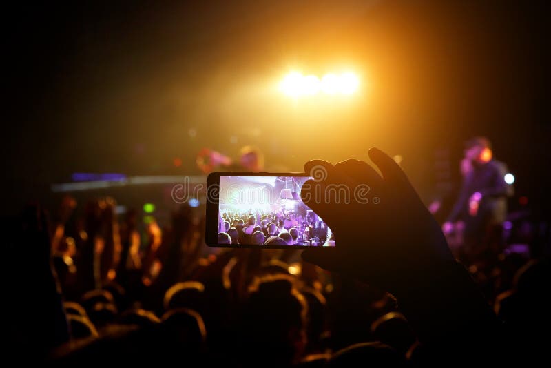 Man Taking Smart Phone at Live Concert and Lights on Stage Stock Photo ...