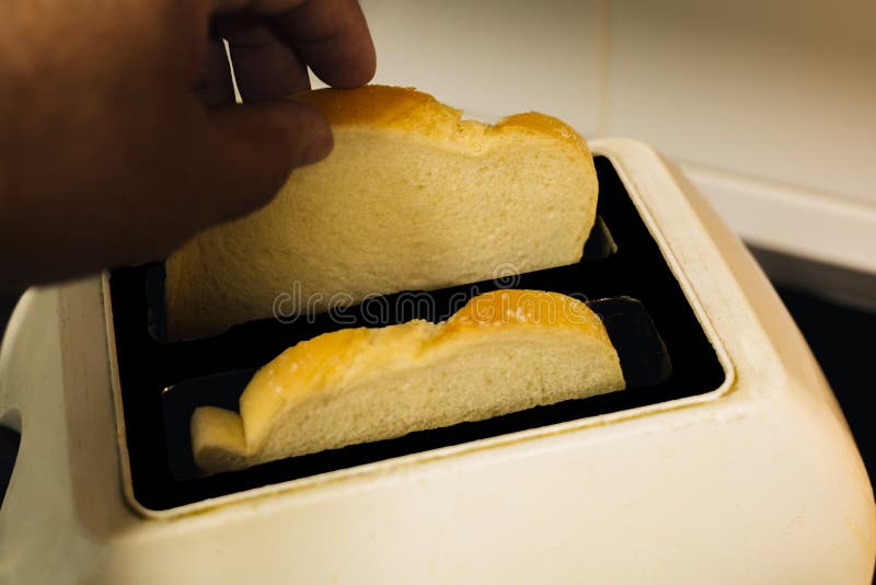 Man Taking Toast Out of the Toast Machine for Breakfast Stock Image ...