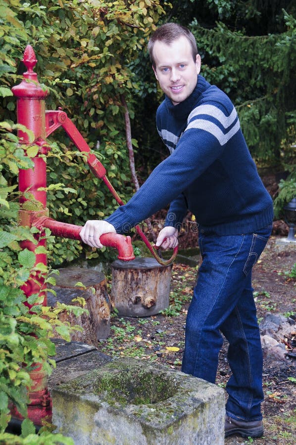 Man Taking Water from Water Well Stock Photo - Image of garden, ancient ...