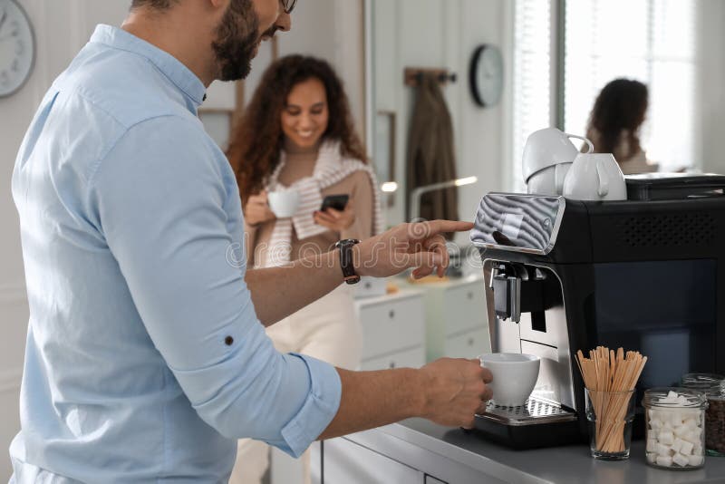 Man Talking with Colleague while Using Modern Coffee Machine in Office ...