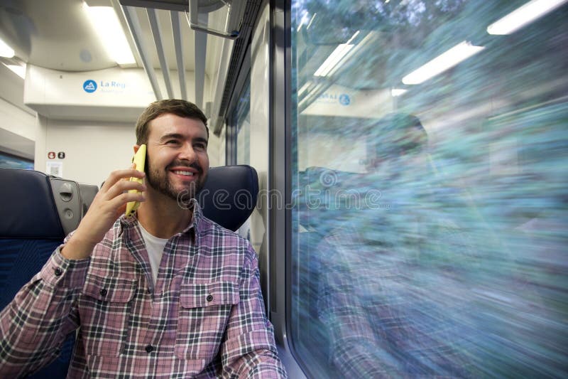 Man Talking on His Cellphone while Traveling by Train Stock Photo ... Man Talking on His Cellphone while Traveling by Train Stock Photo ...