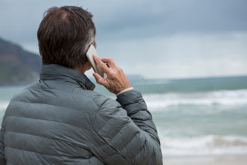 Man Talking on Mobile Phone on Beach Stock Image - Image of travel ...