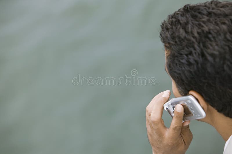 Man Talking on Mobile Phone Over Water Stock Photo - Image of space ...