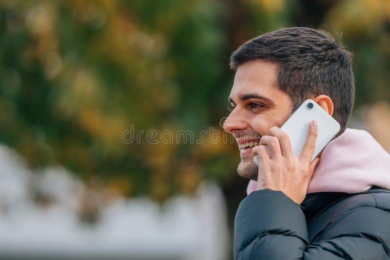Man Talking on Mobile Phone in Profile Outdoors Stock Image - Image of ...