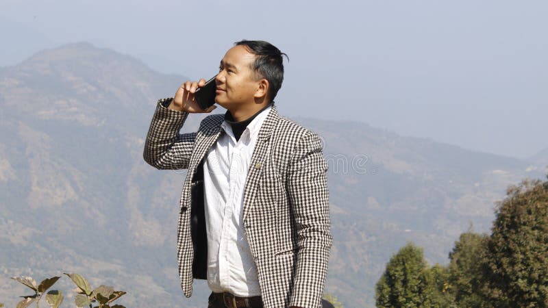 A Man Talking in Mobile Phone Standing on the Hill Village Stock Image ...