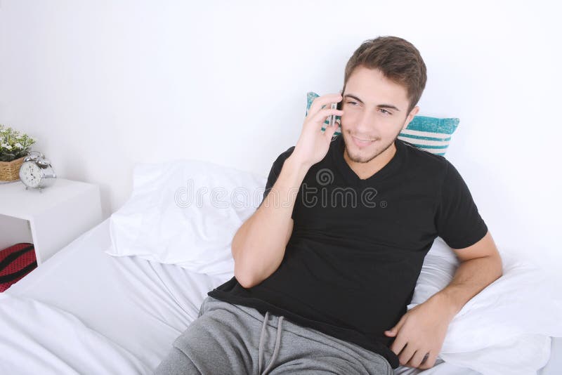 Man Talking on Phone in Bed. Stock Photo - Image of looking, mobile ...