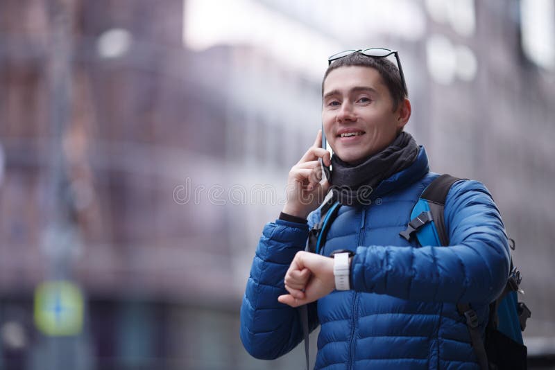 Man Talking on Phone and Looking at Smartwatch Stock Image - Image of ...