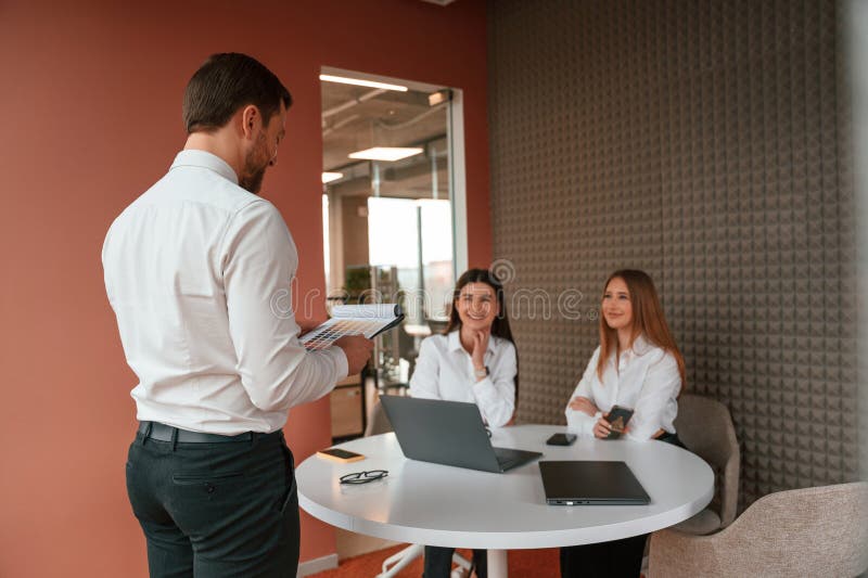 Man is Talking, Showing Documents, Plan of the Project. Three Business ...