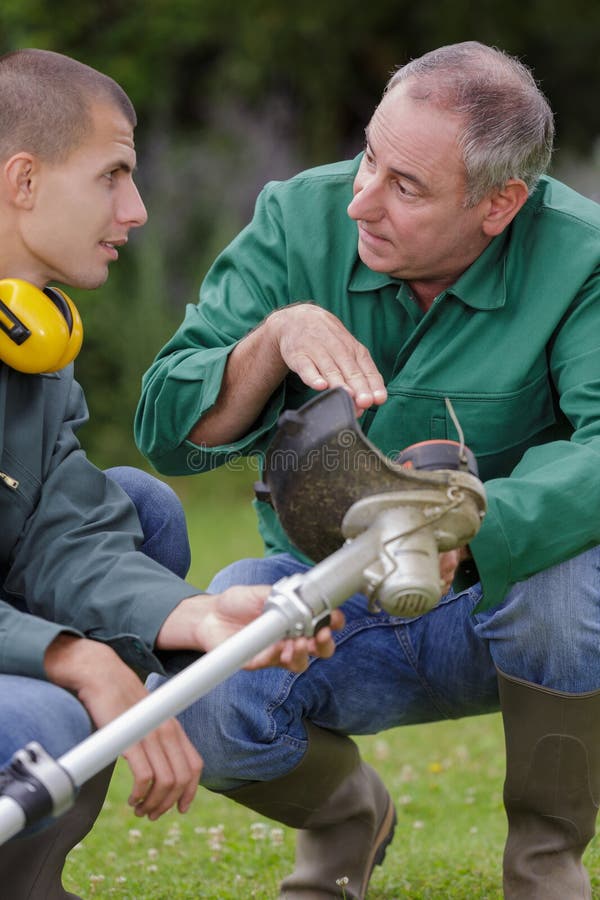 Man Talking To Apprentice about Cutter Engine Stock Photo - Image of ...