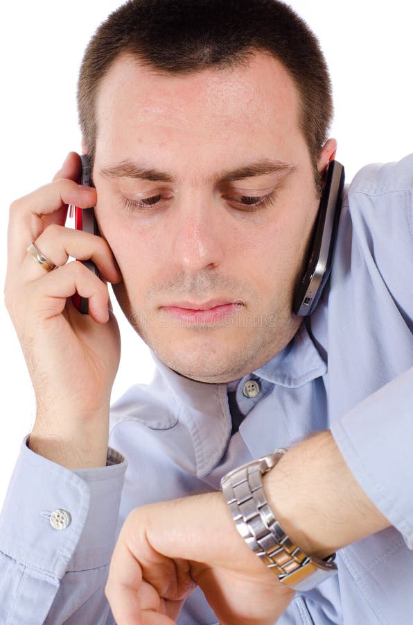 Man Talking on Two Cellphones and Looking at Watch Stock Image - Image ...
