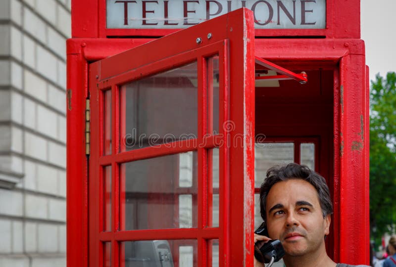 A Man is Talking in a Typical London Phone Booth Stock Image - Image of ...