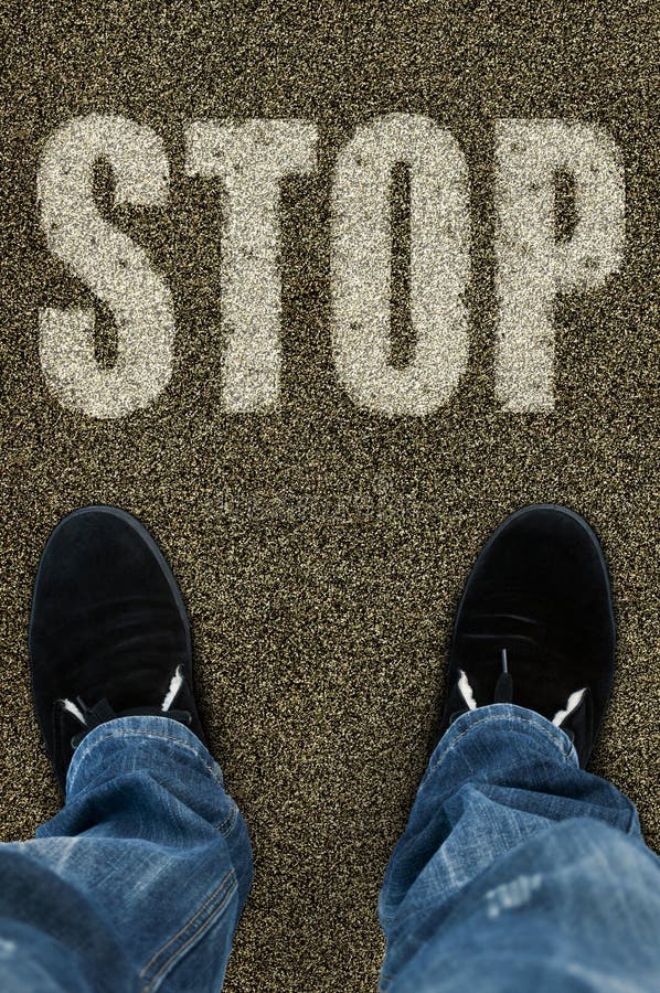 Man On A Tarmac Road With The Word Stop Stock Image - Image of summer ...