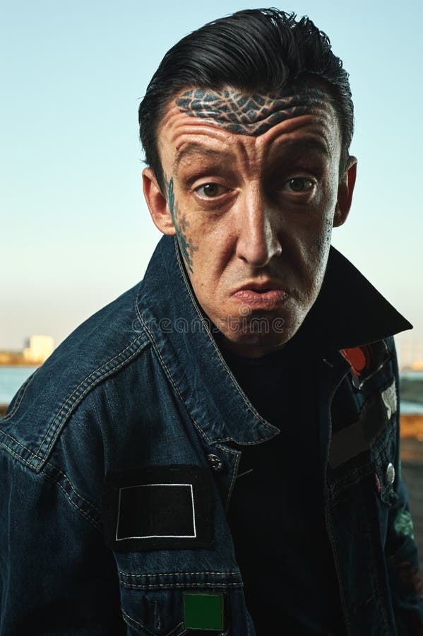 Hooligan with Tattooed Face in Denim Jacket Making Faces Stock Image ...