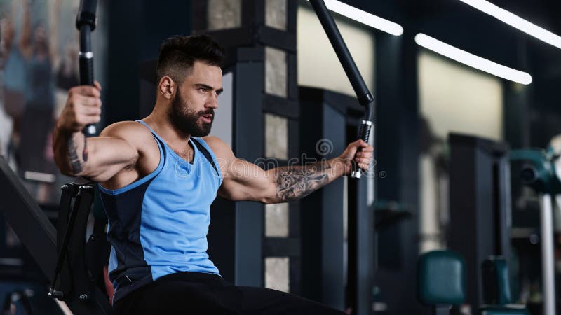 Man Working Out on Cable Machine in Gym Stock Image - Image of athlete ...
