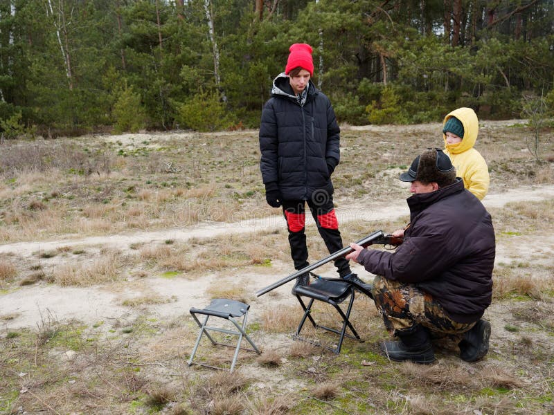 Man Teaches Children Shooting with Hunting Rifle Stock Photo - Image of ...