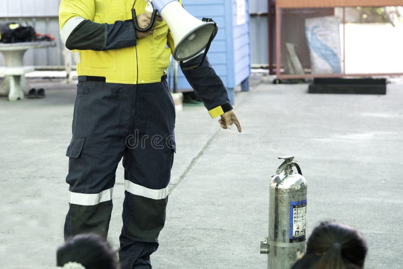 Man Teaches How To Use Fire Extinguisher To Extinguish Fire. Stock ...
