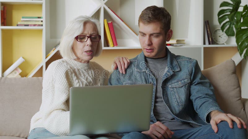 Man Teaching His Mother Using Laptop at Home, Technology Concept. Stock ...