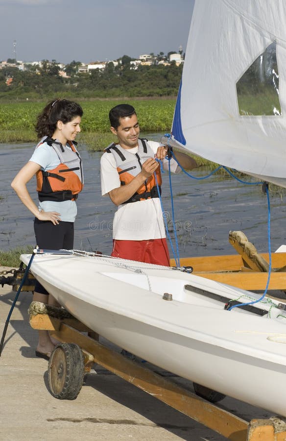 Man Teaching Woman To Sail on Land - Vertical Stock Image - Image of ...