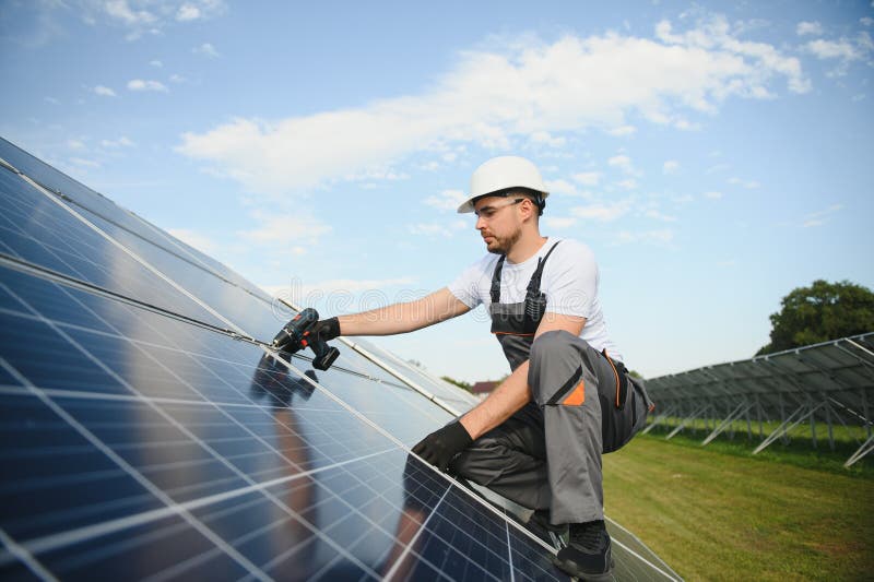 Man Technician Mounting Photovoltaic Solar Moduls. Engineer in Helmet ...