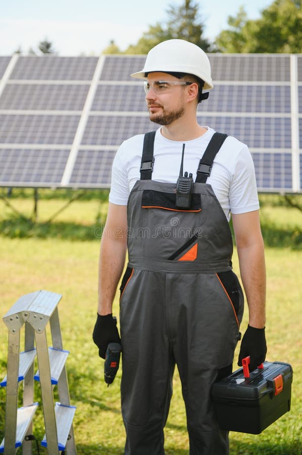 Man Technician Mounting Photovoltaic Solar Moduls. Engineer in Helmet ...
