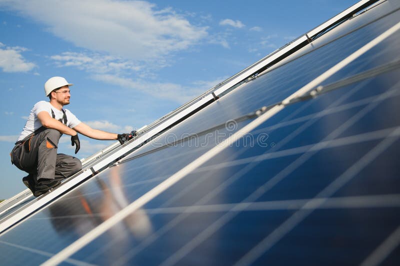 Man Technician Mounting Photovoltaic Solar Moduls. Engineer in Helmet ...