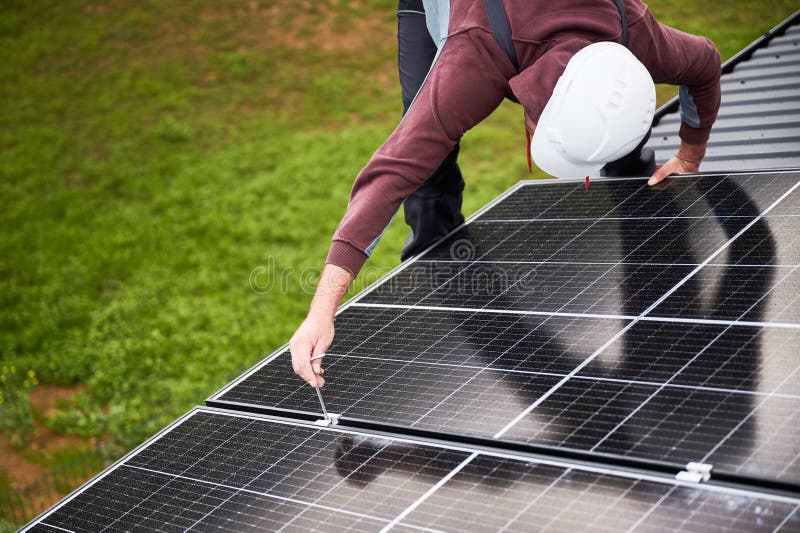 Man Technician Mounting Photovoltaic Solar Panels on Roof of House with ...