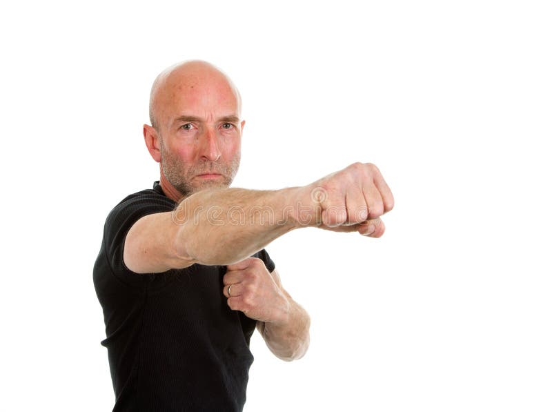 Man in Teeshirt Throwing a Punch Stock Photo - Image of male, black ...