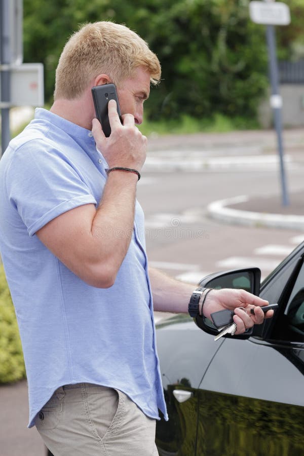 Man on Telephone while Using Remote Central Locking Key Stock Photo ...