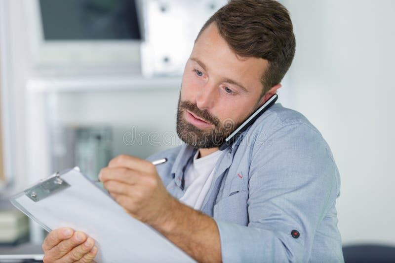 Man on Telephone Writing on Clipboard Stock Image - Image of phone ...