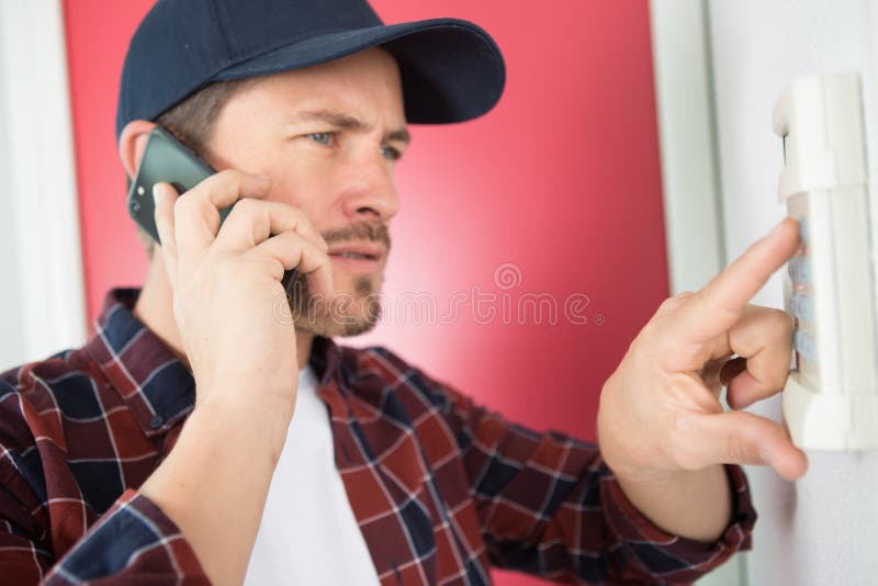 Man Telephoning for Support To Enter Code in Electronic Keypad Stock ...