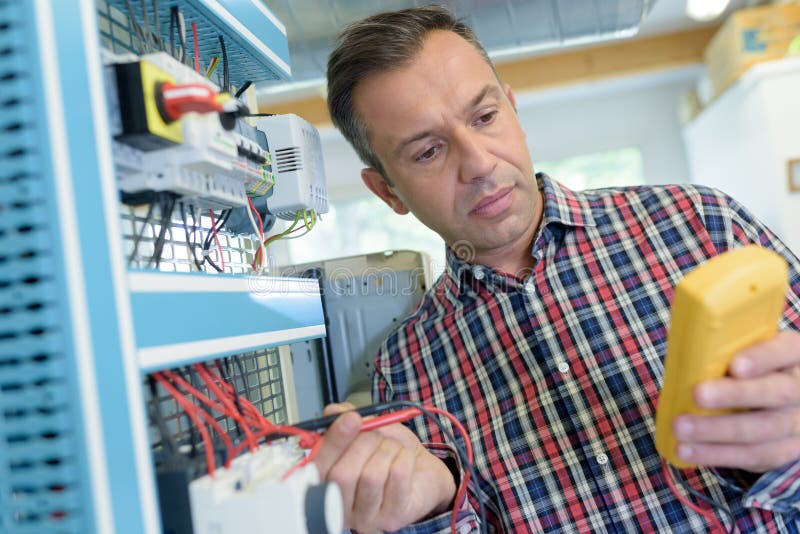 Man Testing Electronic System with Multimeter Stock Photo - Image of ...