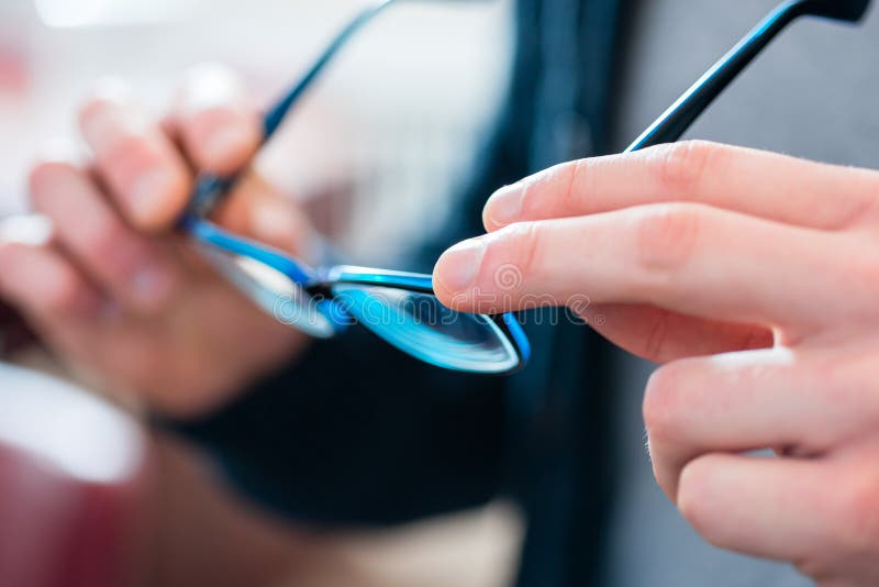 Man Testing Glasses at Optician Shop in His Hand Stock Photo - Image of ...