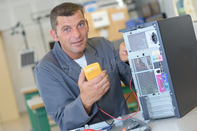 Man Testing Tower Computer with Multimeter Stock Photo - Image of ...