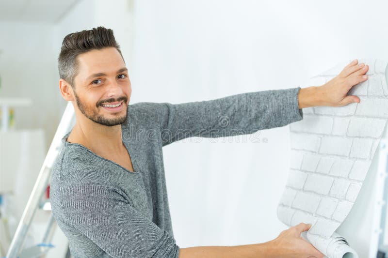 Man Testing Wall Paper on Wall Stock Photo - Image of working, sheet ...