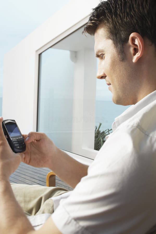 Man Text Messaging on Porch Stock Image - Image of caucasian, texting ...