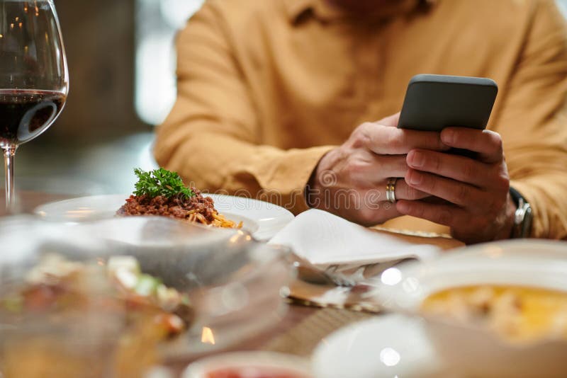 Man Texting Friends stock photo. Image of meal, table - 260934356