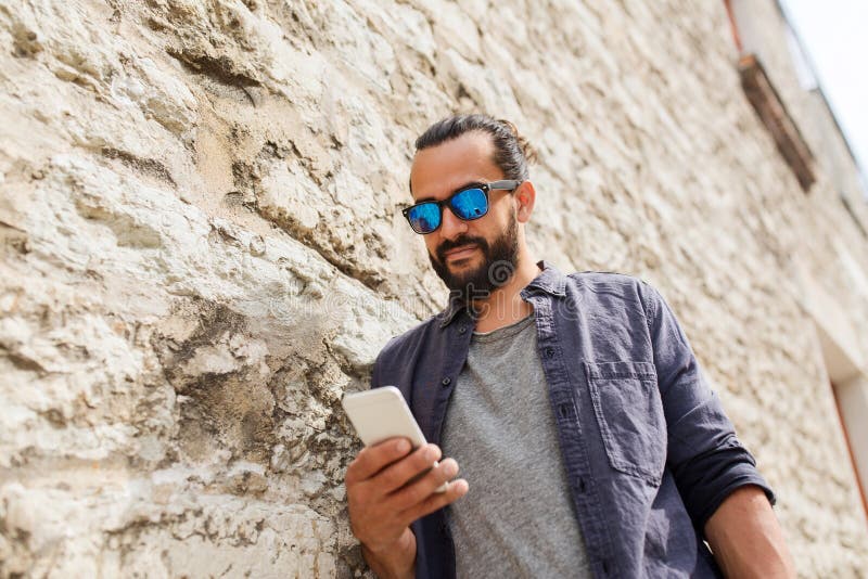 Man Texting Message on Smartphone at Stone Wall Stock Photo - Image of ...