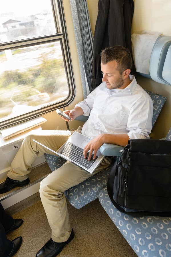 Man Texting on Phone Holding Laptop Train Stock Image - Image of ...