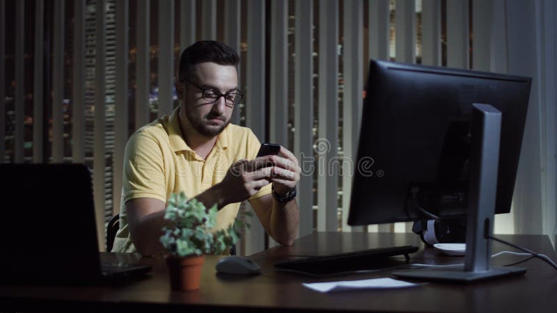 Man Using Phone in Office at Night Stock Photo - Image of entrepreneur ...