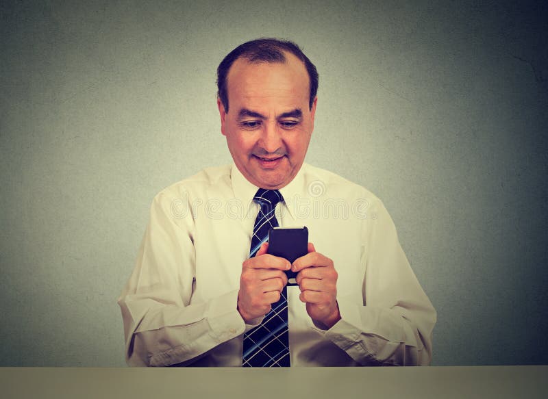 Man Texting on Smart Phone Sitting at Table Stock Photo - Image of ...